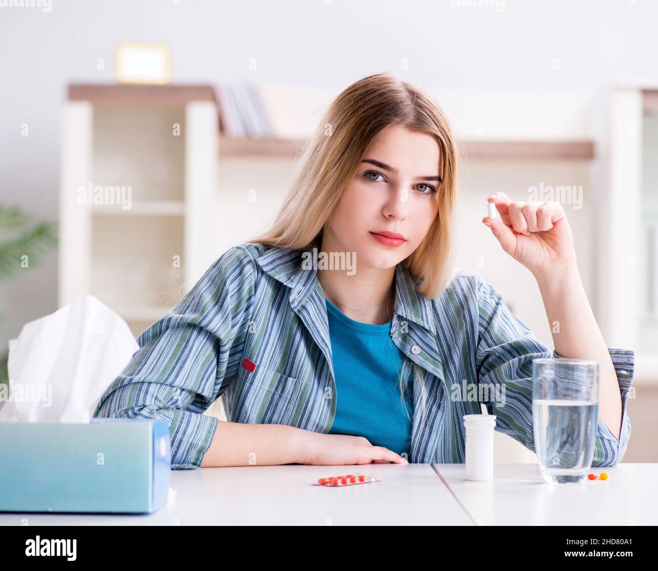 The woman taking pills to cope with pain Stock Photo - Alamy
