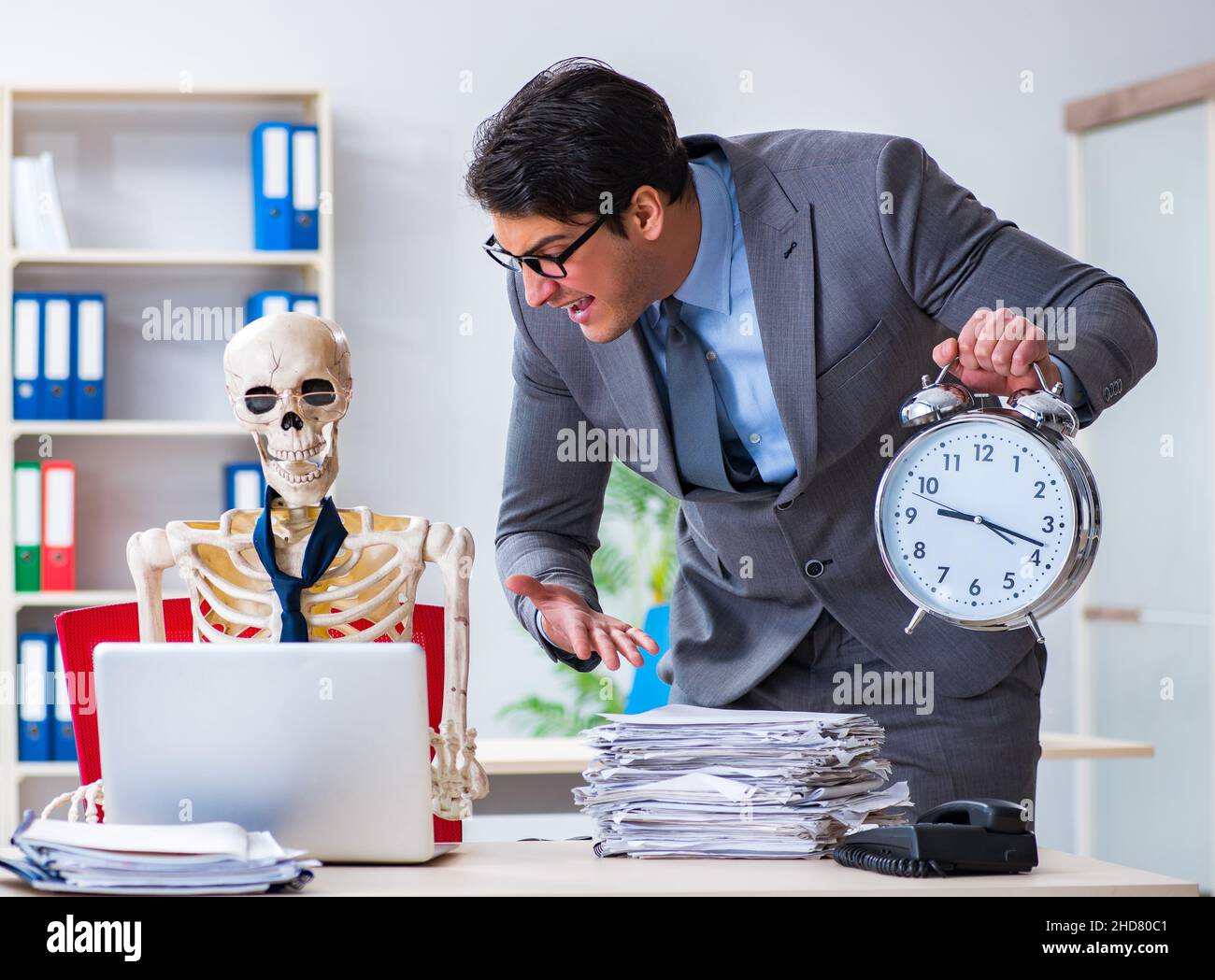 The angry boss yelling at his skeleton employee Stock Photo - Alamy