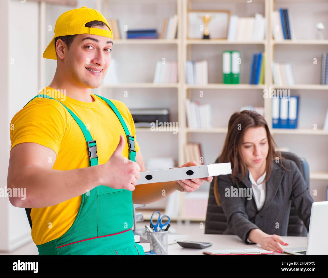The postman delivering parcel to the office Stock Photo - Alamy