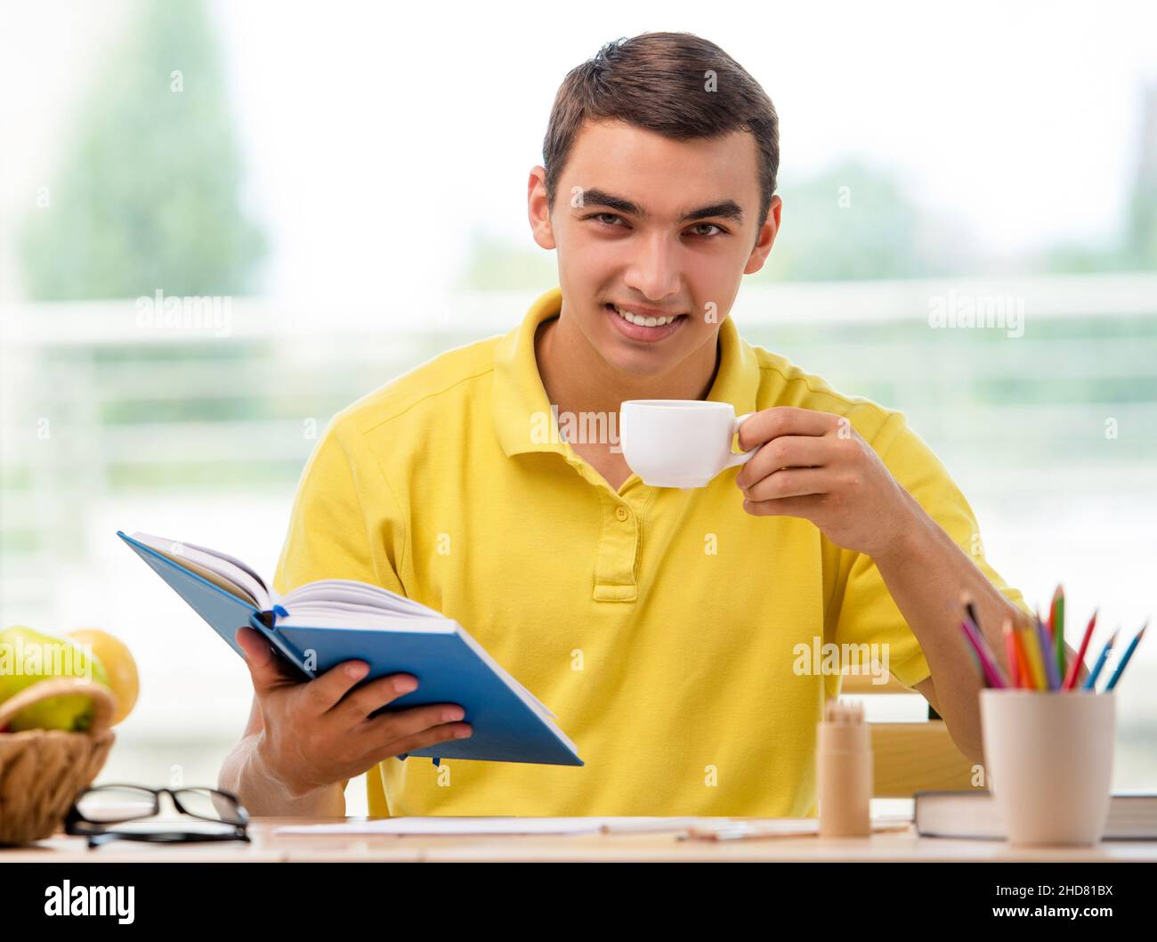 The student reading book and drinking tea Stock Photo - Alamy