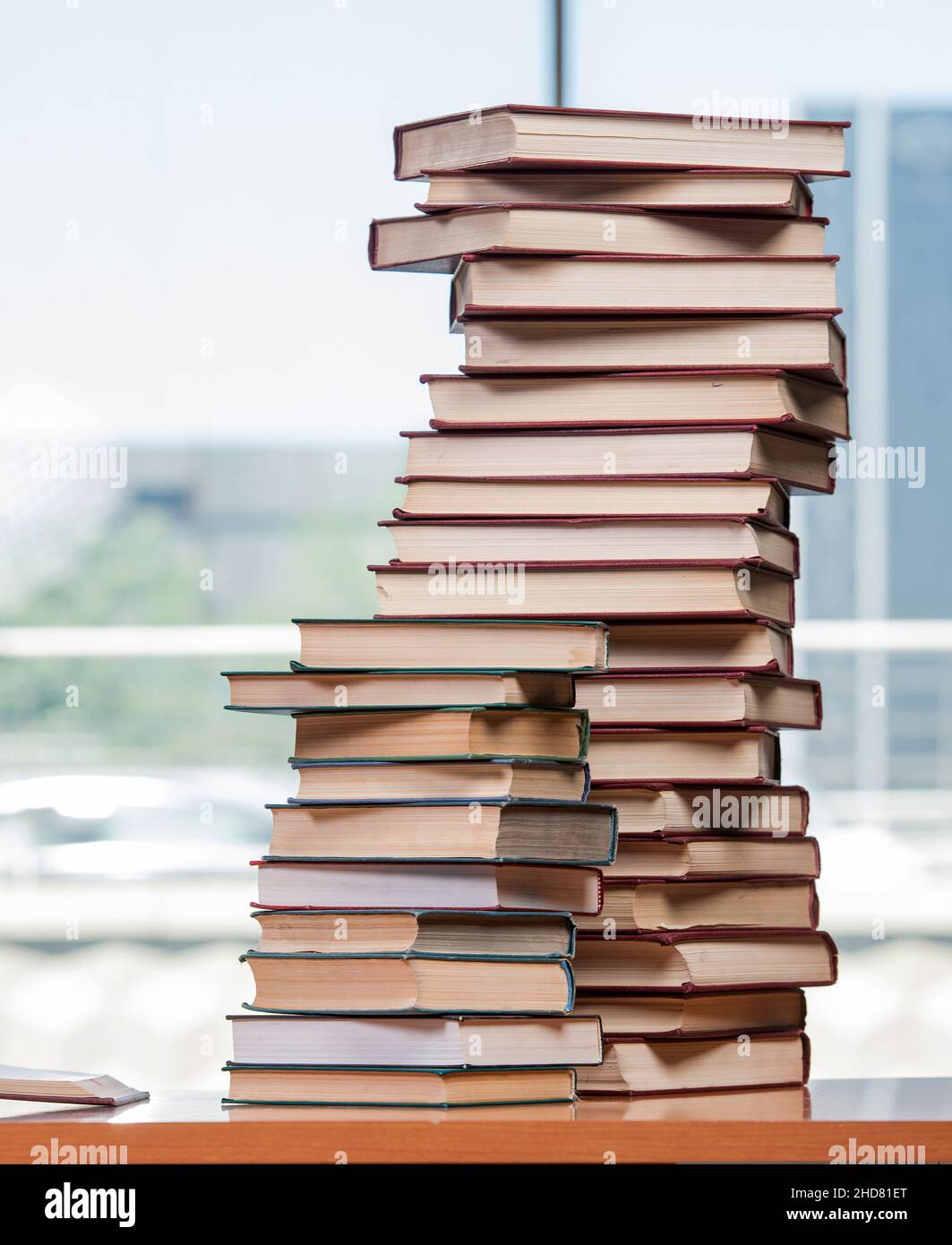 The stack of books on the desk in education concept Stock Photo - Alamy