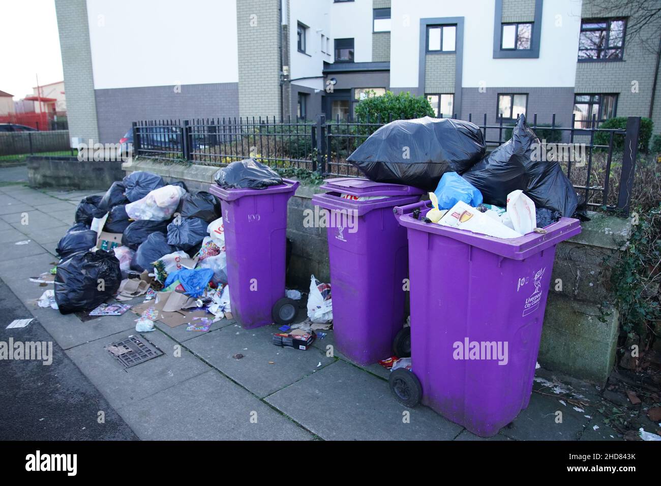 Overflowing bins awaiting collection by refuse workers on Cherry Street ...