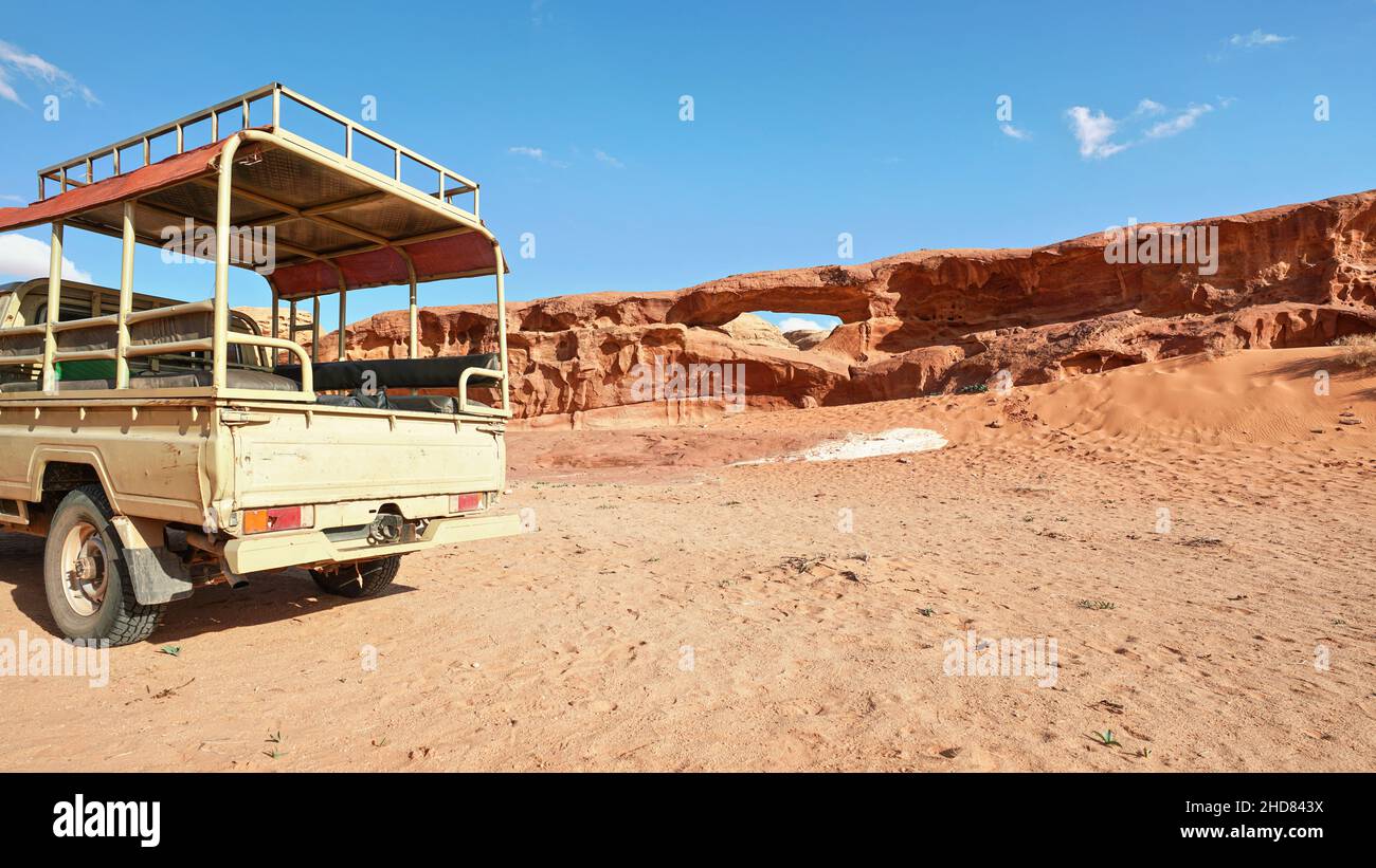 Little arc or small rock window formation in Wadi Rum desert, blue sky ...