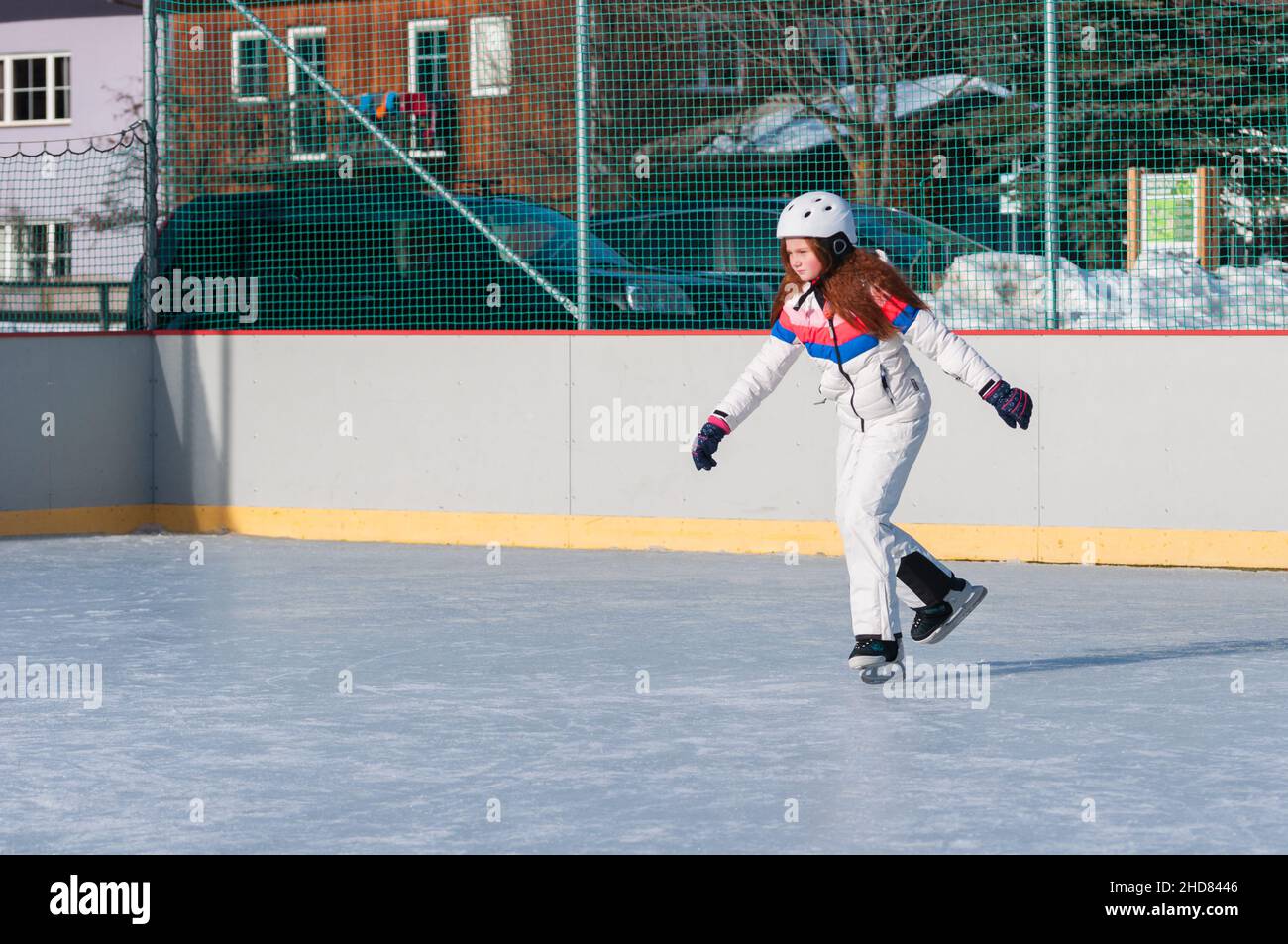 red hair girl skating on an ice skating rink Stock Photo - Alamy