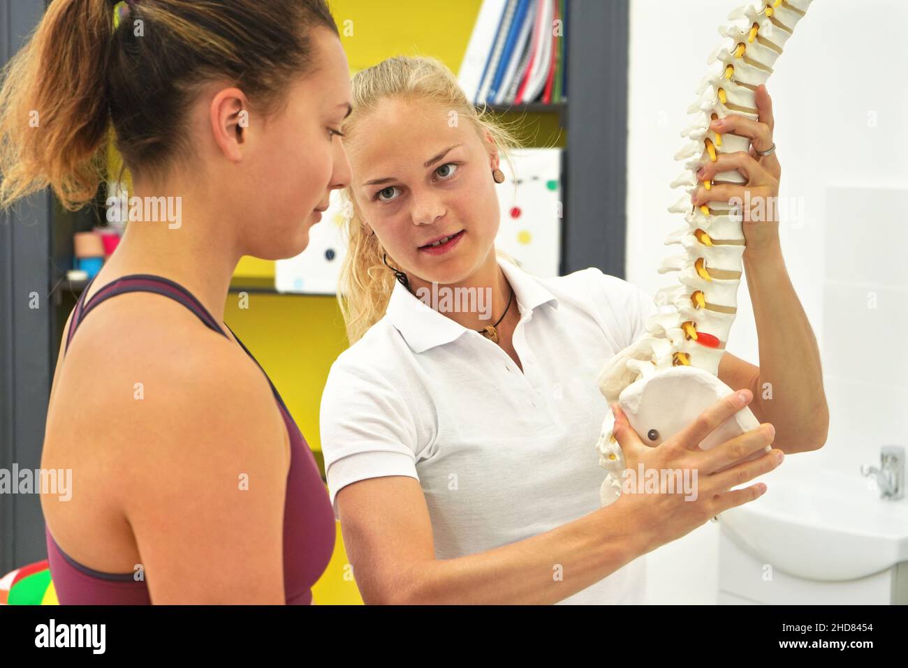Young woman patient at physiotherapy consultation, physiotherapist ...