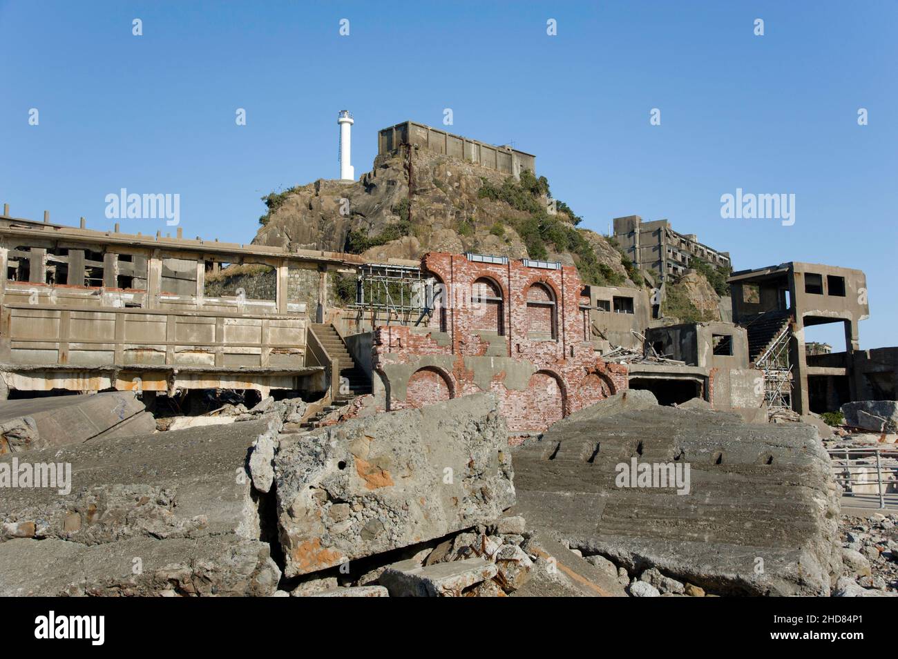 Ruins of several buildings on the abandoned island of Hashima, also ...