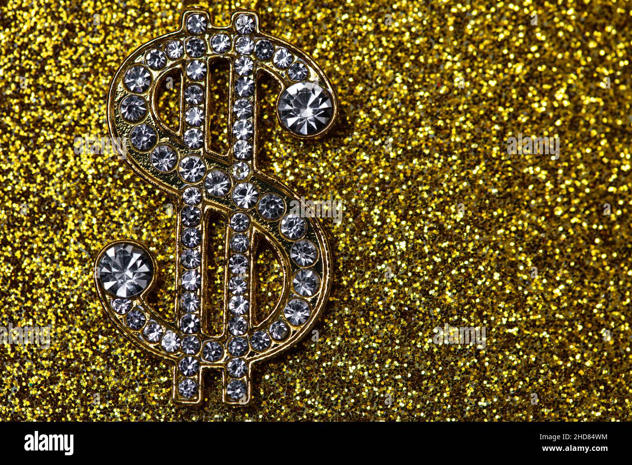 golden dollar sign with gemstones on yellow glitter background for ...