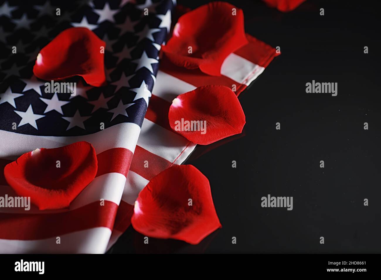 American flag and rose flower on table. Symbol of the United States of ...