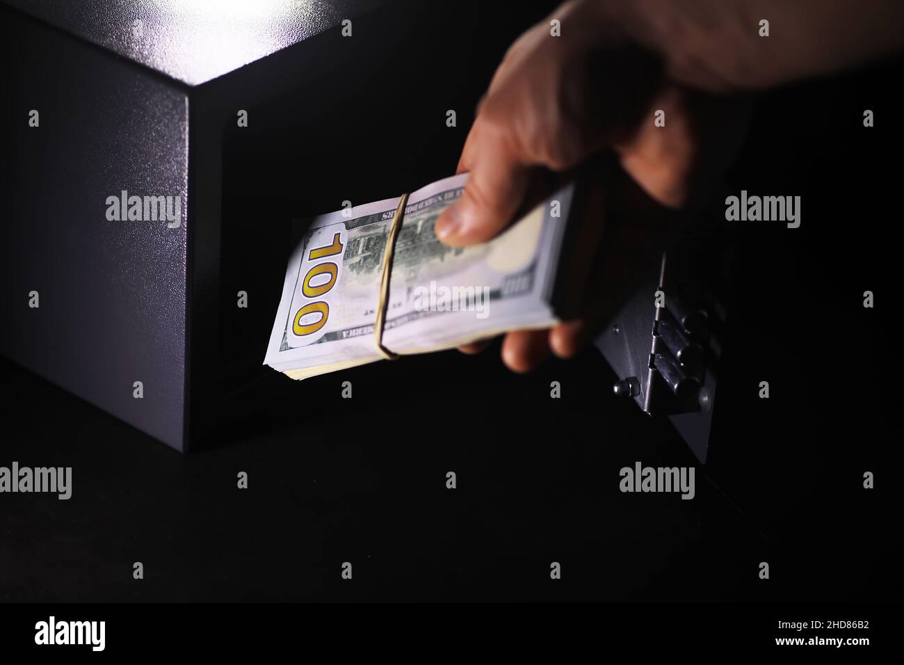 Steel safe with money. Hand putting password in the safety money box in ...