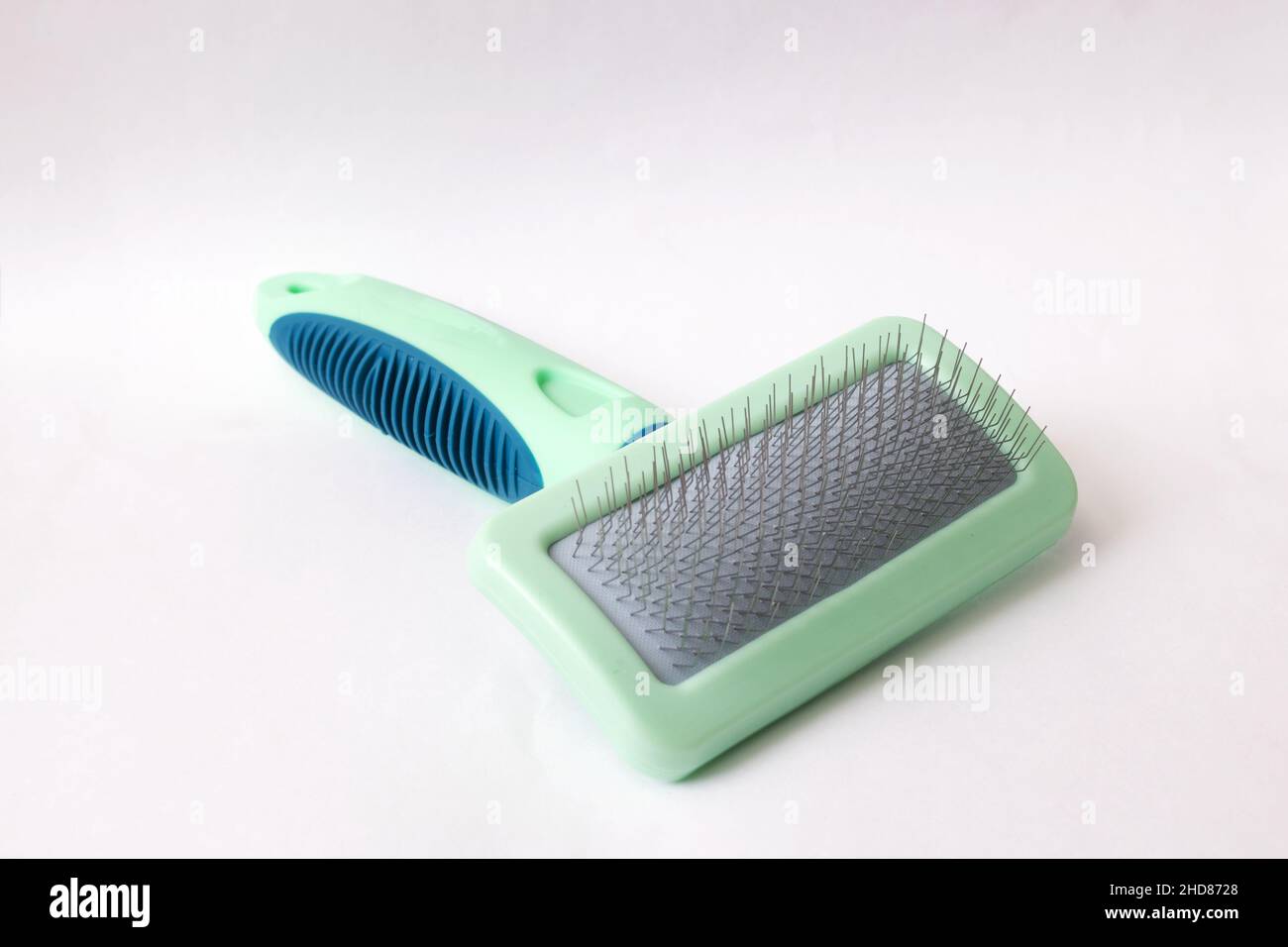 Green animal comb on white background close up Stock Photo - Alamy