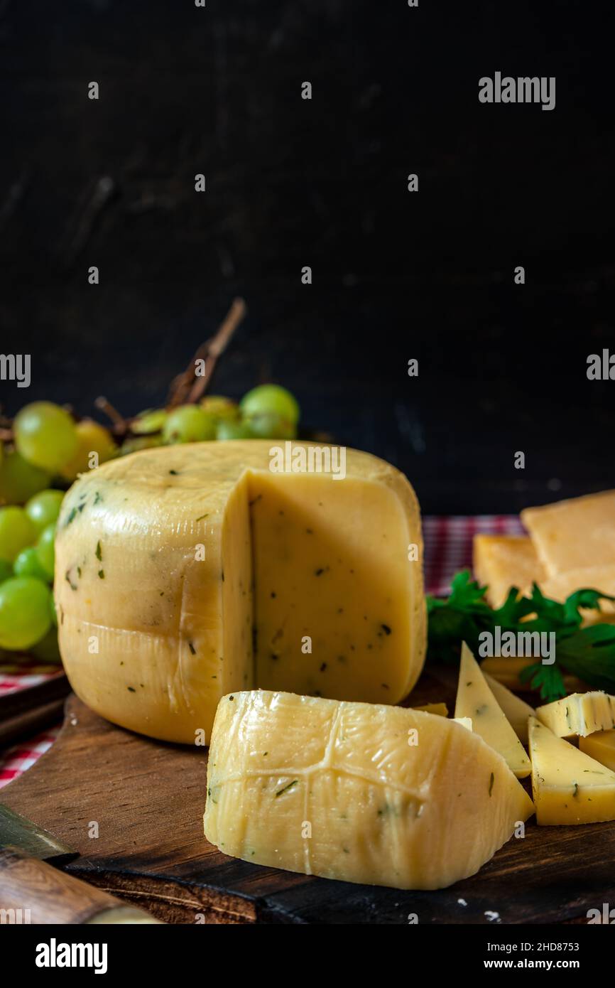 A normal view of a delicious small piece spiced cheese on a board next ...