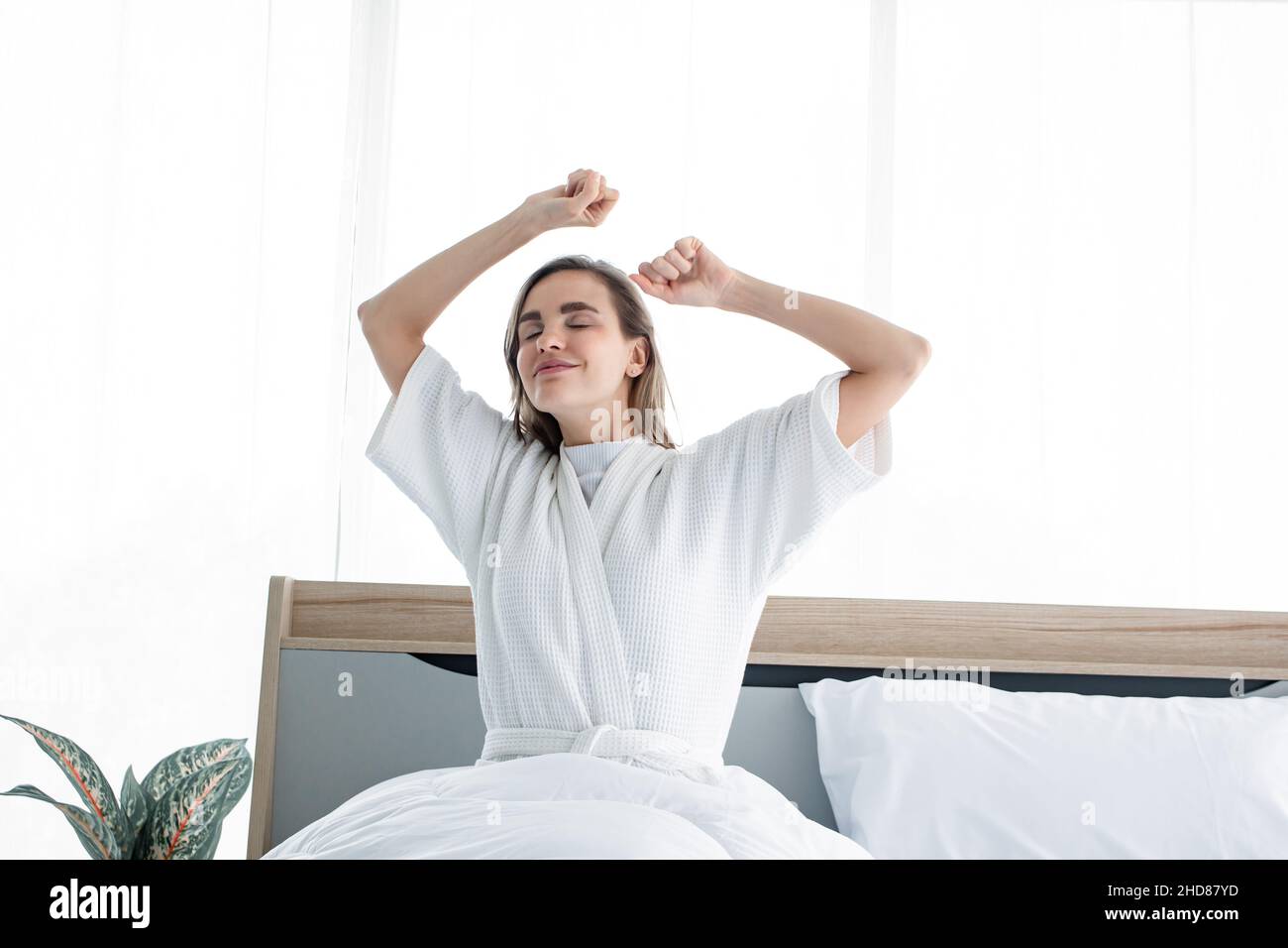 Woman stretching after waking up in the morning. Beautiful women wake ...