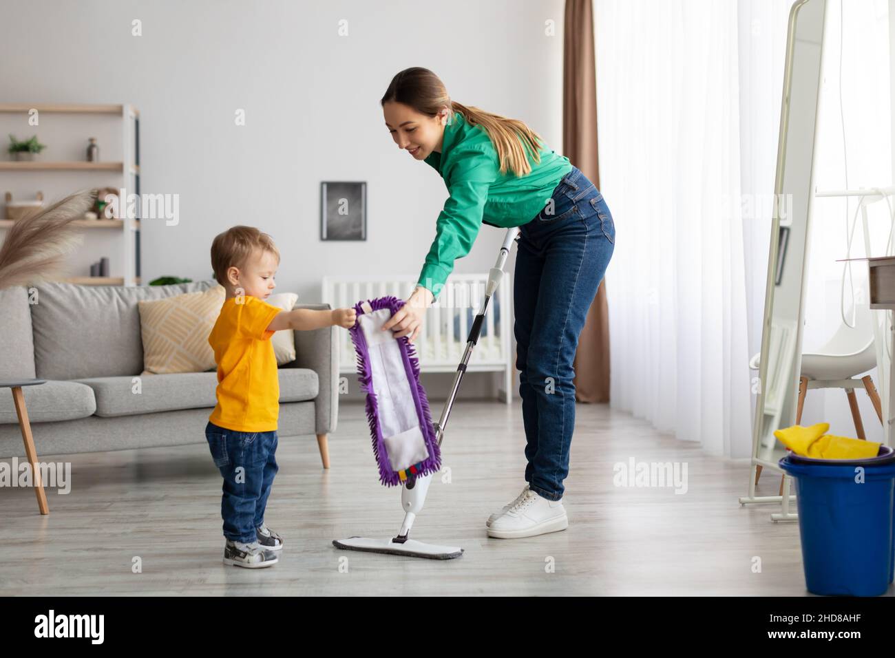 Happy family cleaning the room. Mother and toddler son doing the ...