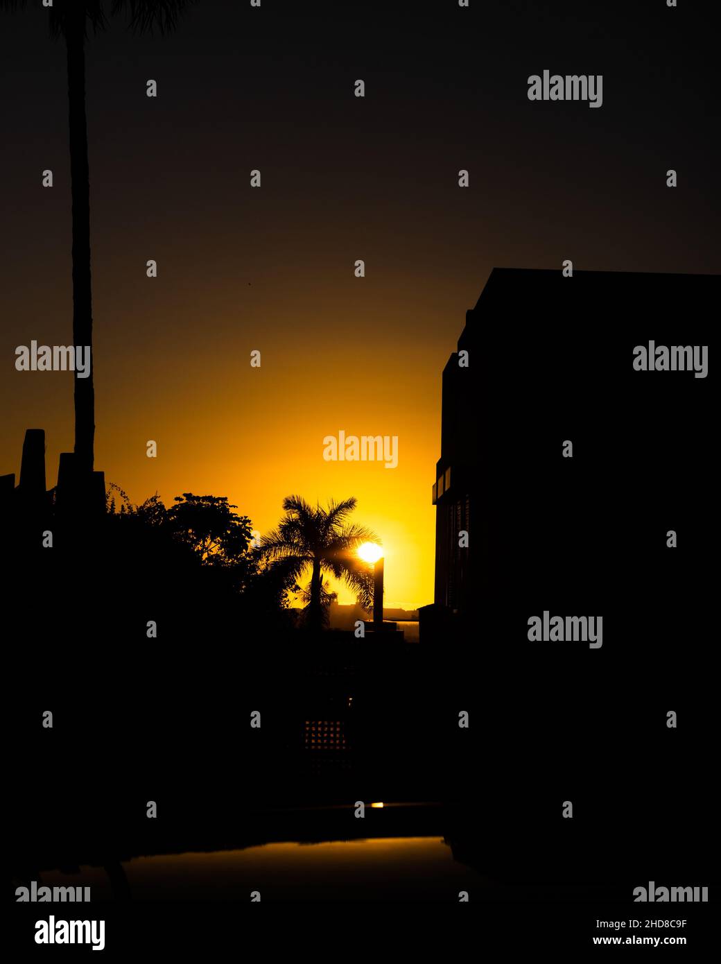 Sun getting down between buildings Stock Photo - Alamy