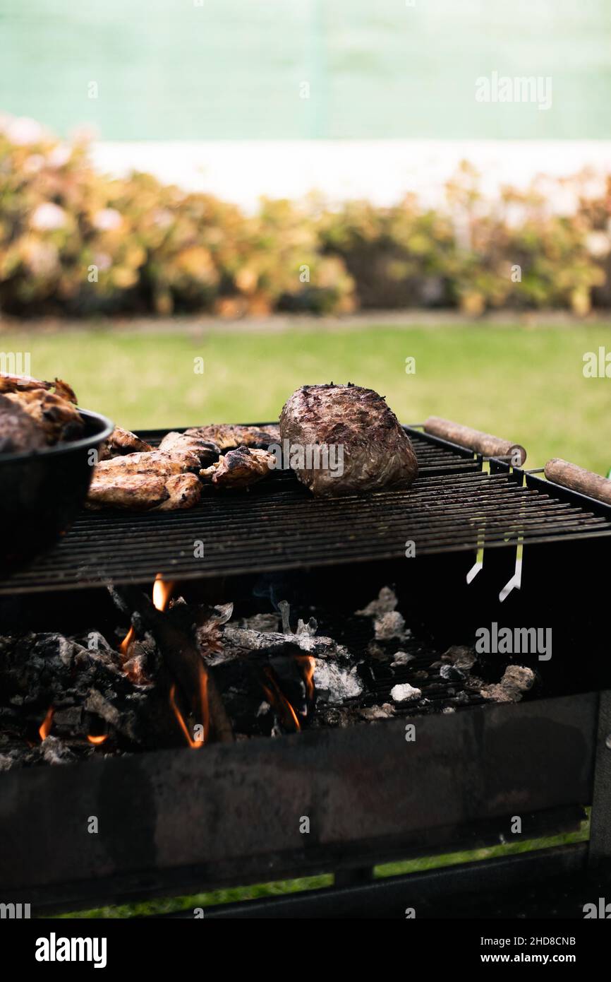 Cooking meat and vegetables on a grill Stock Photo - Alamy