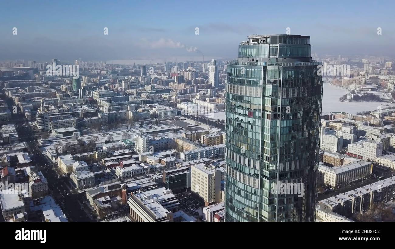 Aerial view of skyscraper is in the middle of the city in winter, blue ...