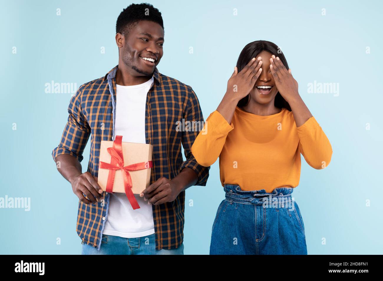 Happy black man making surprise for his woman giving box Stock Photo ...