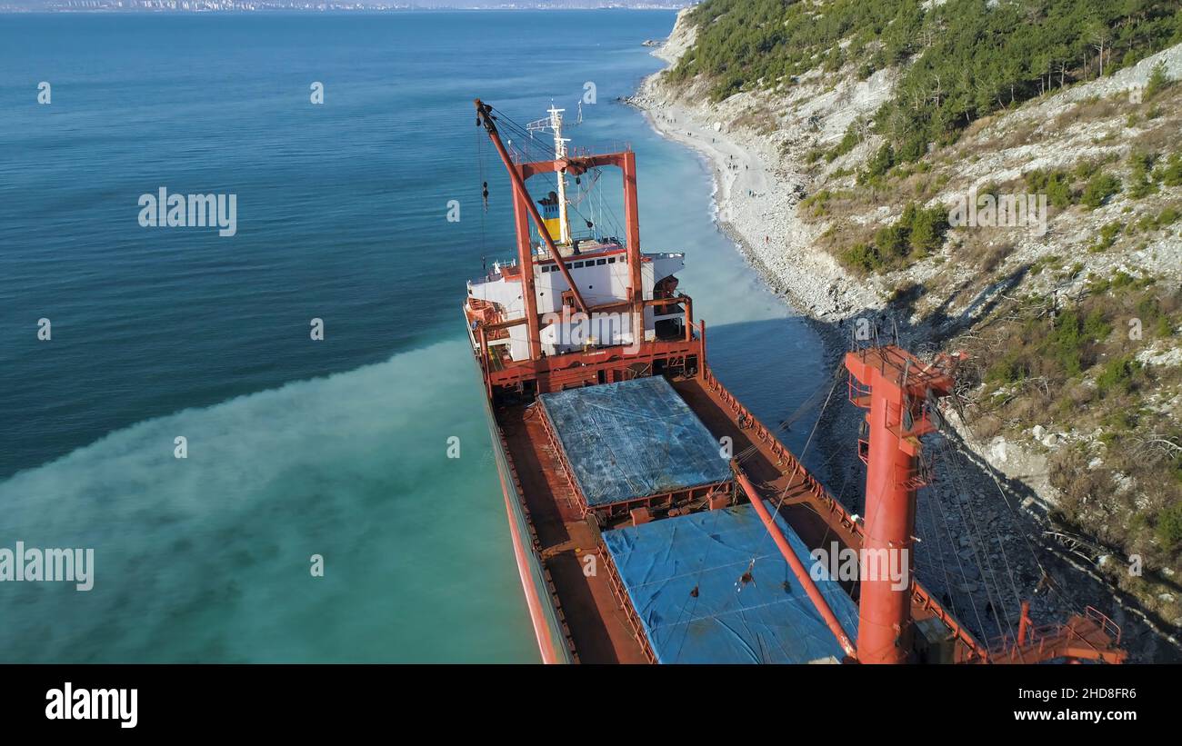 Aerial top view of an empty, red barge moored near the beautiful blue ...