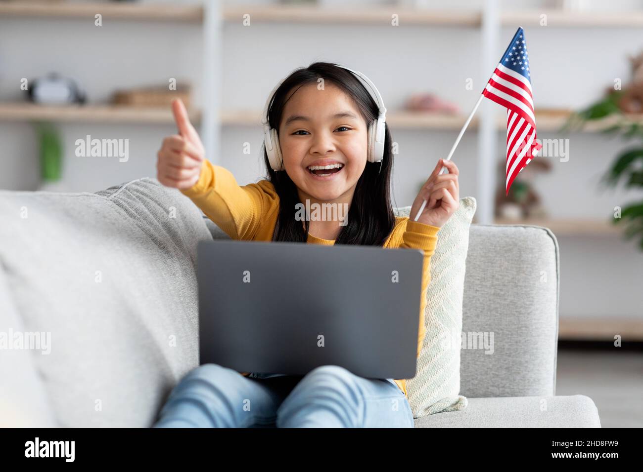 Happy asian kid learning English on Internet Stock Photo - Alamy