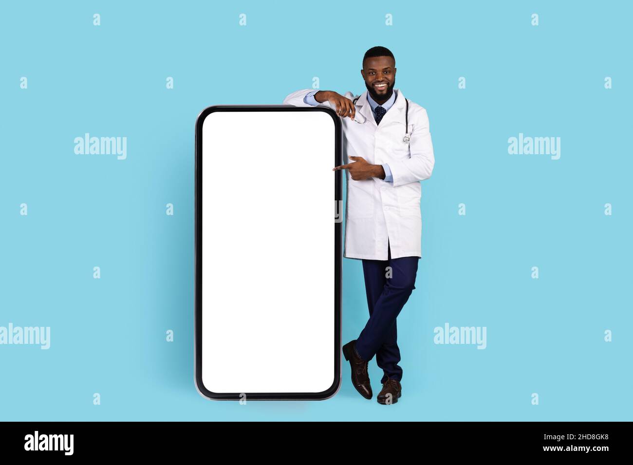 Smiling Black Doctor In Uniform Pointing At Blank Phone With White ...