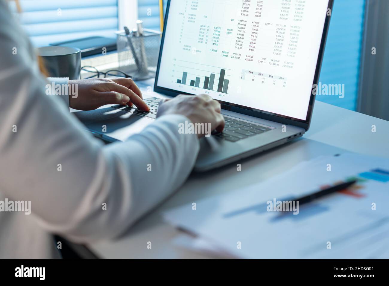 Overwork Concept The office worker typing something on the notebook in ...