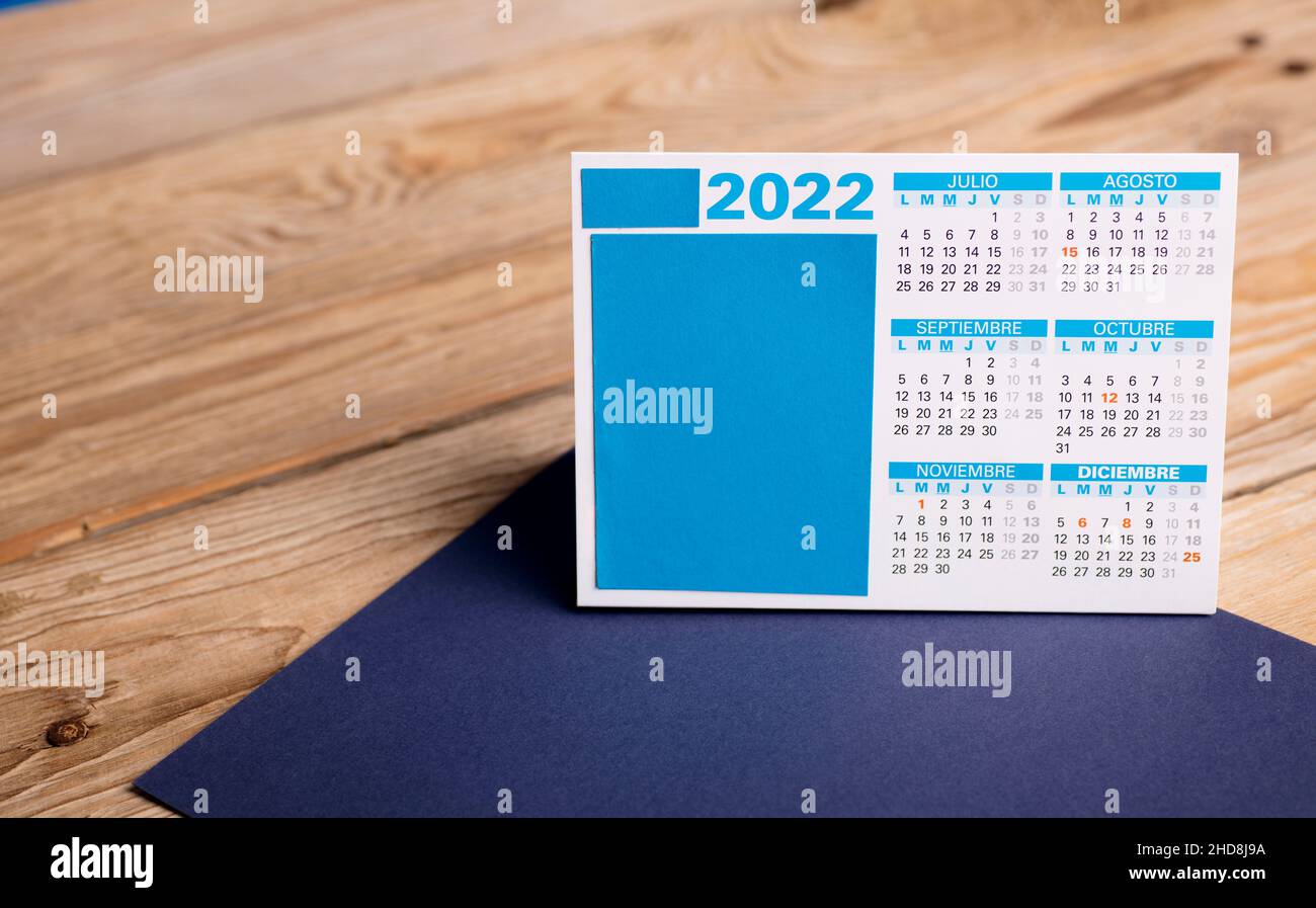 2022 calendar (months in Spanish) , on notepad, wooden desk table with ...