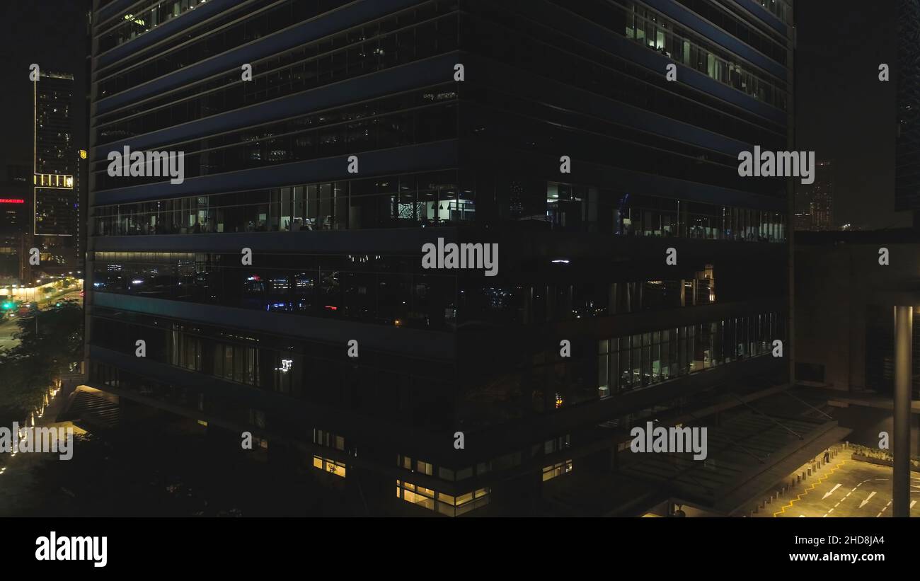 Frontal view of the night facade of building with a lot of lighted ...