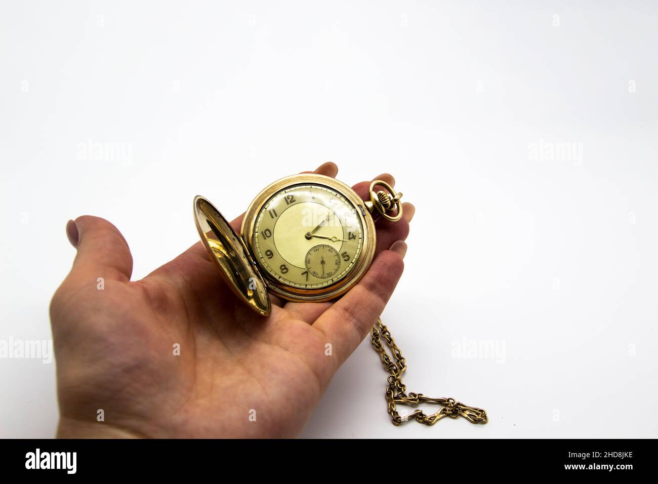 Vintage golden old pocket watch on the hand against white background ...