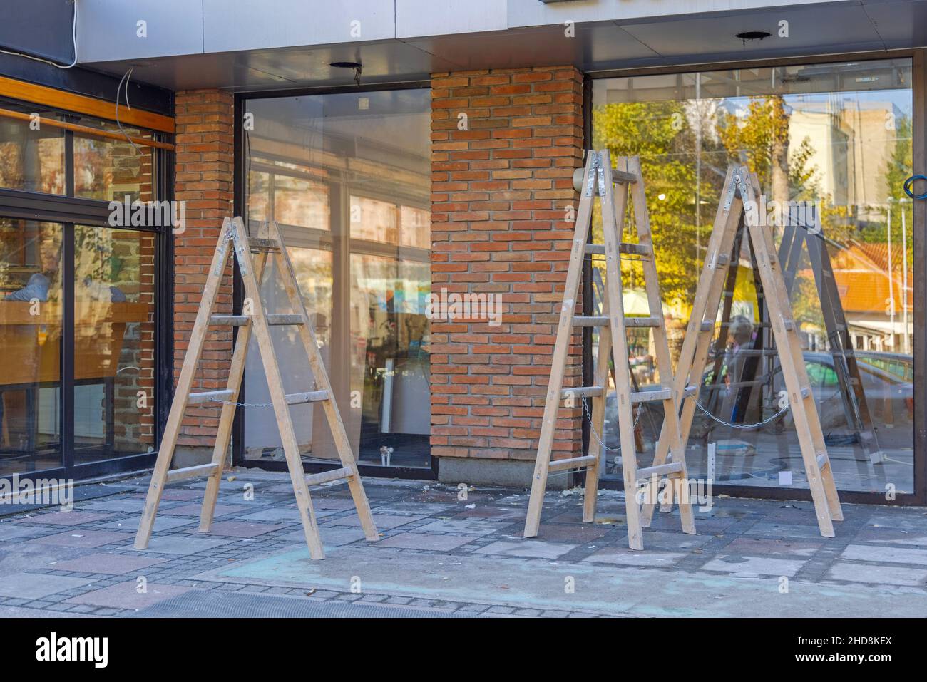 Workers Wooden Ladders in Front of Shop Window Stock Photo - Alamy