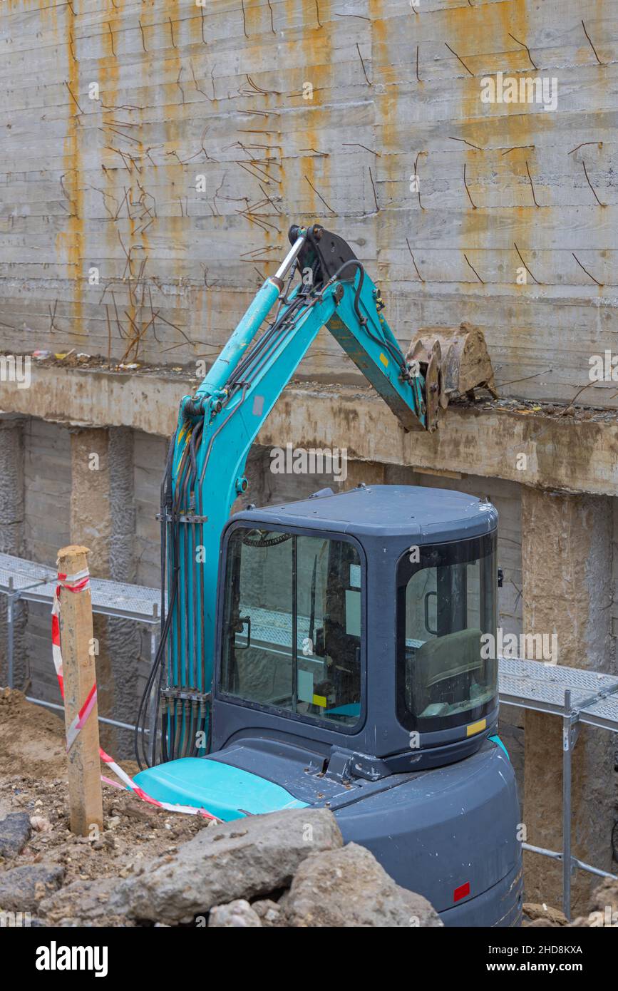 Small Digger Machine in Underground Basement Concrete Construction Site ...