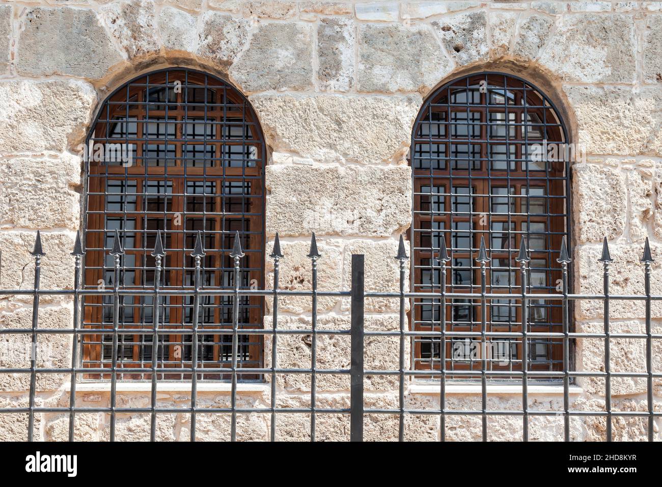 Window of old building close up with metal safety grille. Traditional ...
