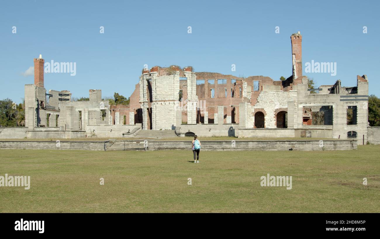 A woman stands in front of the ruins of Dungeness mansion on Cumberland ...