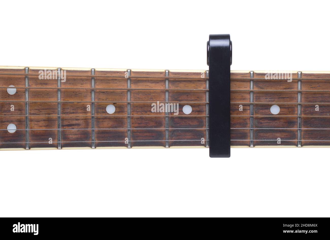 Guitar capo on acoustic fretboard Stock Photo - Alamy