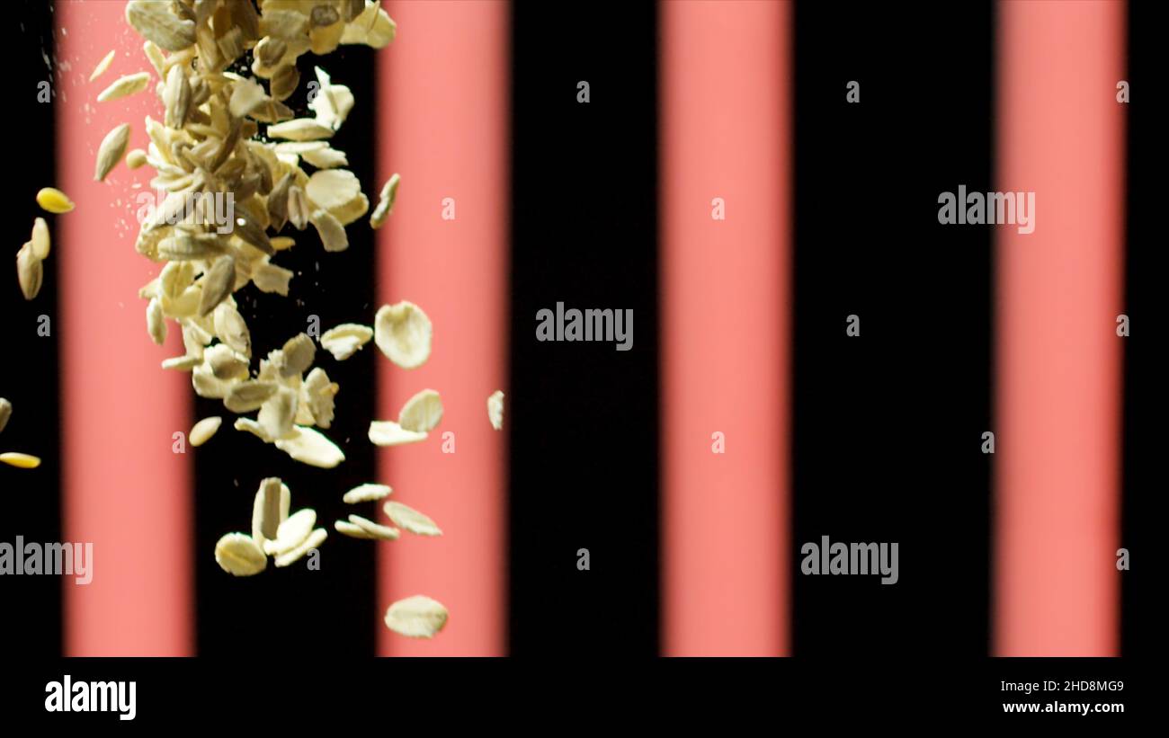 Close up of oat flakes falling down. Oatmeal splash, small flakes ...