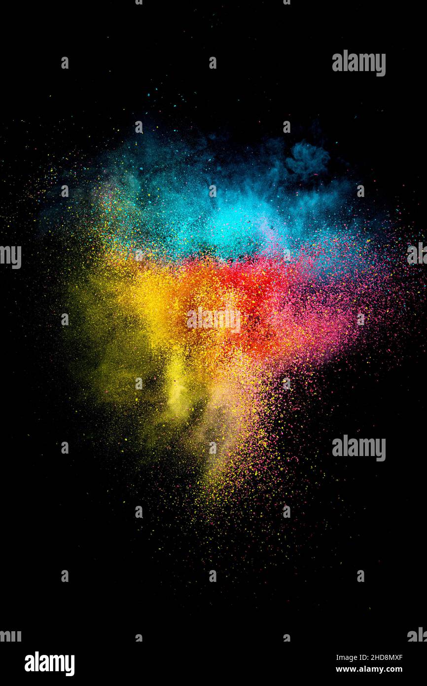 Explosion of colored, fluid and neoned powder on black studio ...