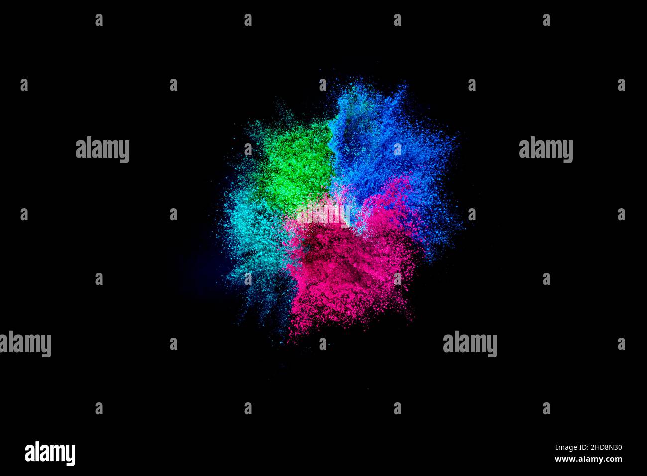 Explosion of colored, fluid and neoned powder on black studio ...