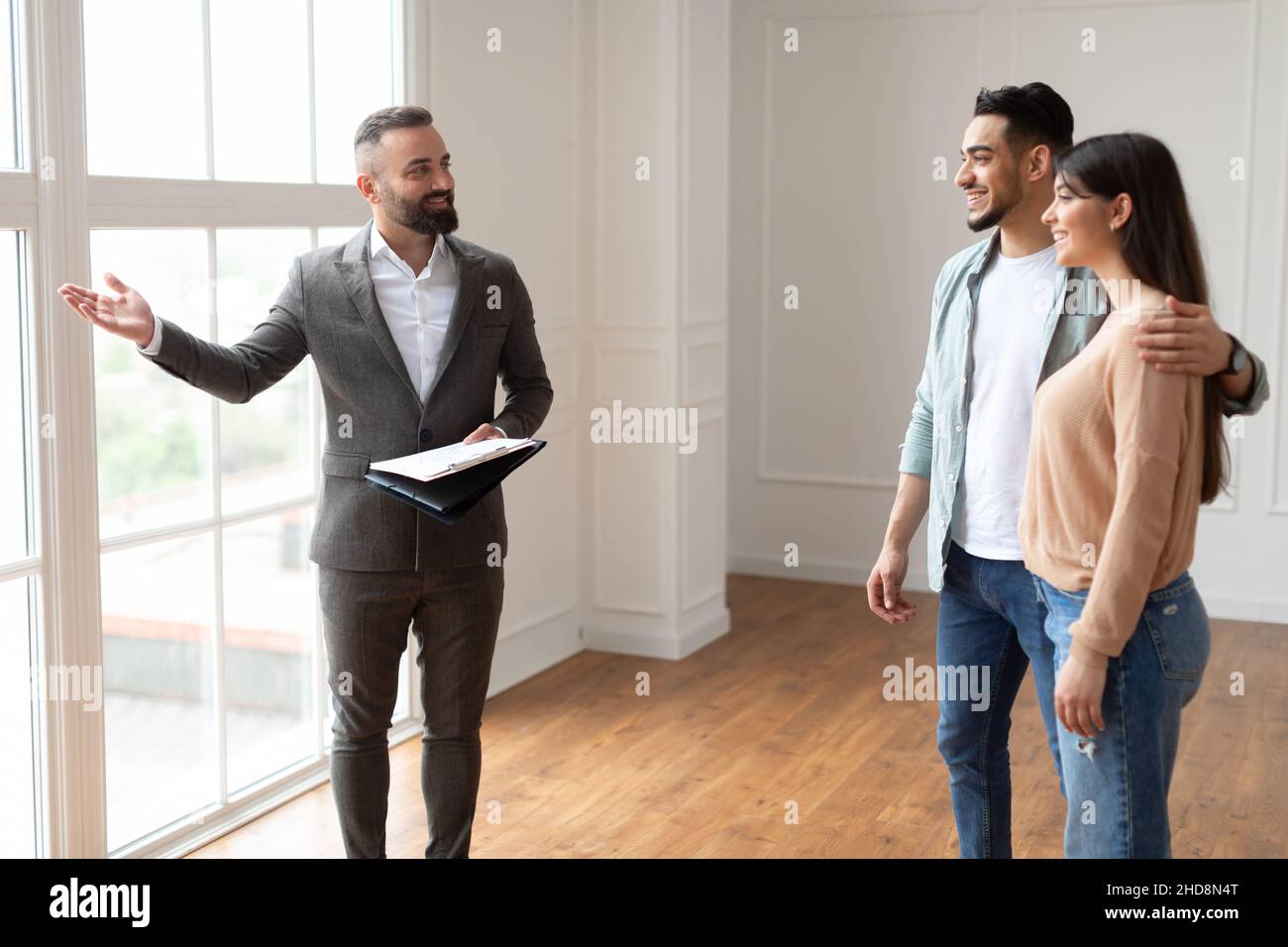 Estate Agent Showing Property For Young Buyers Stock Photo - Alamy