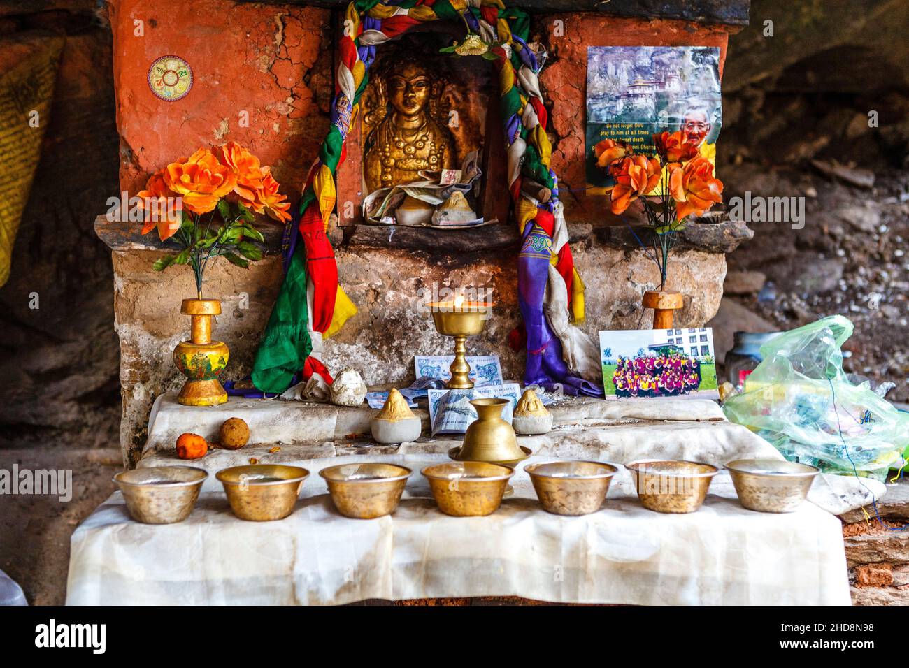 Altar with butter lamps, money and other offerings for Lord Buddha ...