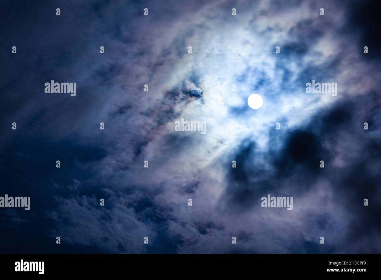 Clouds pass in front of the moon in a night sky Stock Photo - Alamy