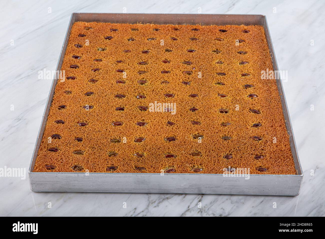 Turkish Dessert Kadayif on a tray decorated with pistachios. Turkish ...
