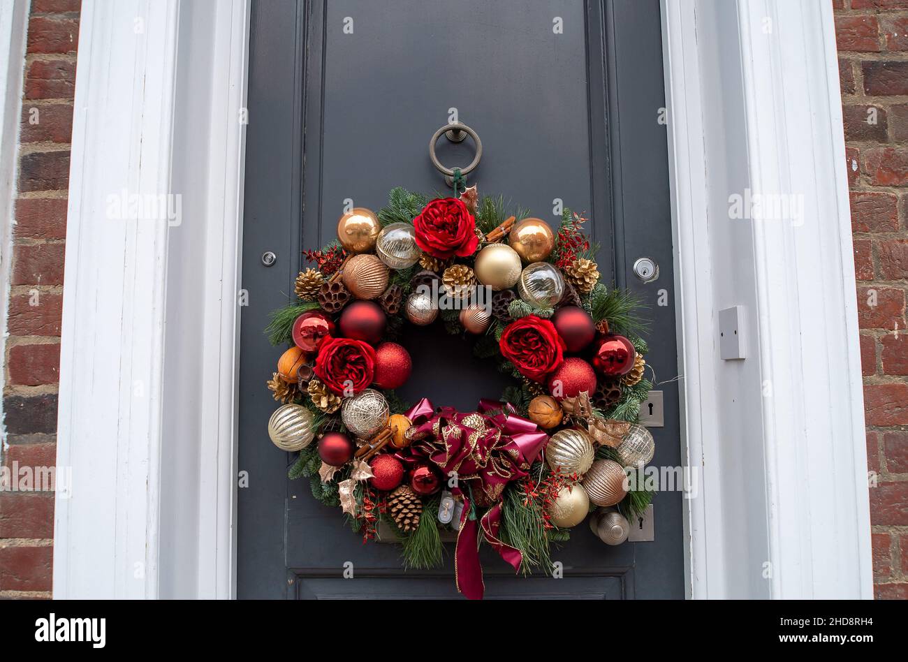 Windsor, Berkshire, UK. 17th December, 2021. A holly bough on a front ...