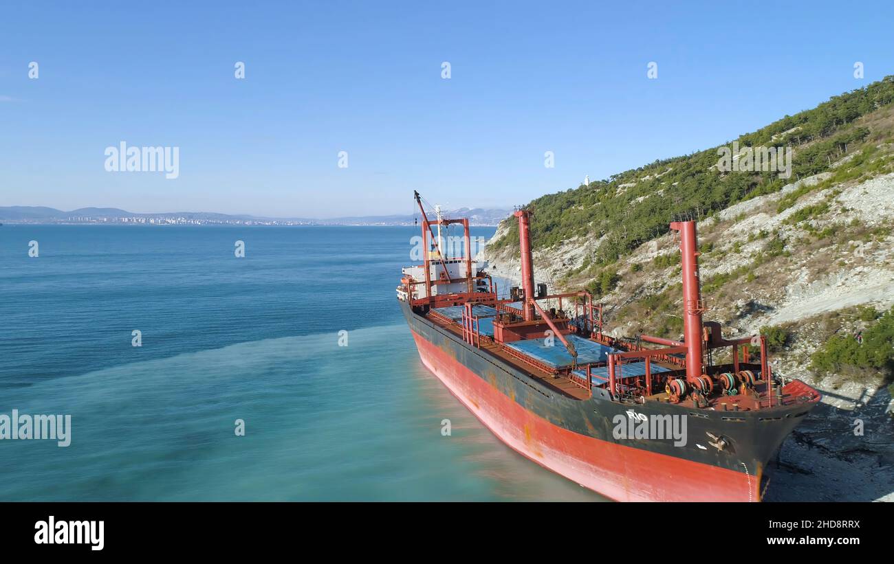 Aerial top view of an empty, red barge moored near the beautiful blue ...