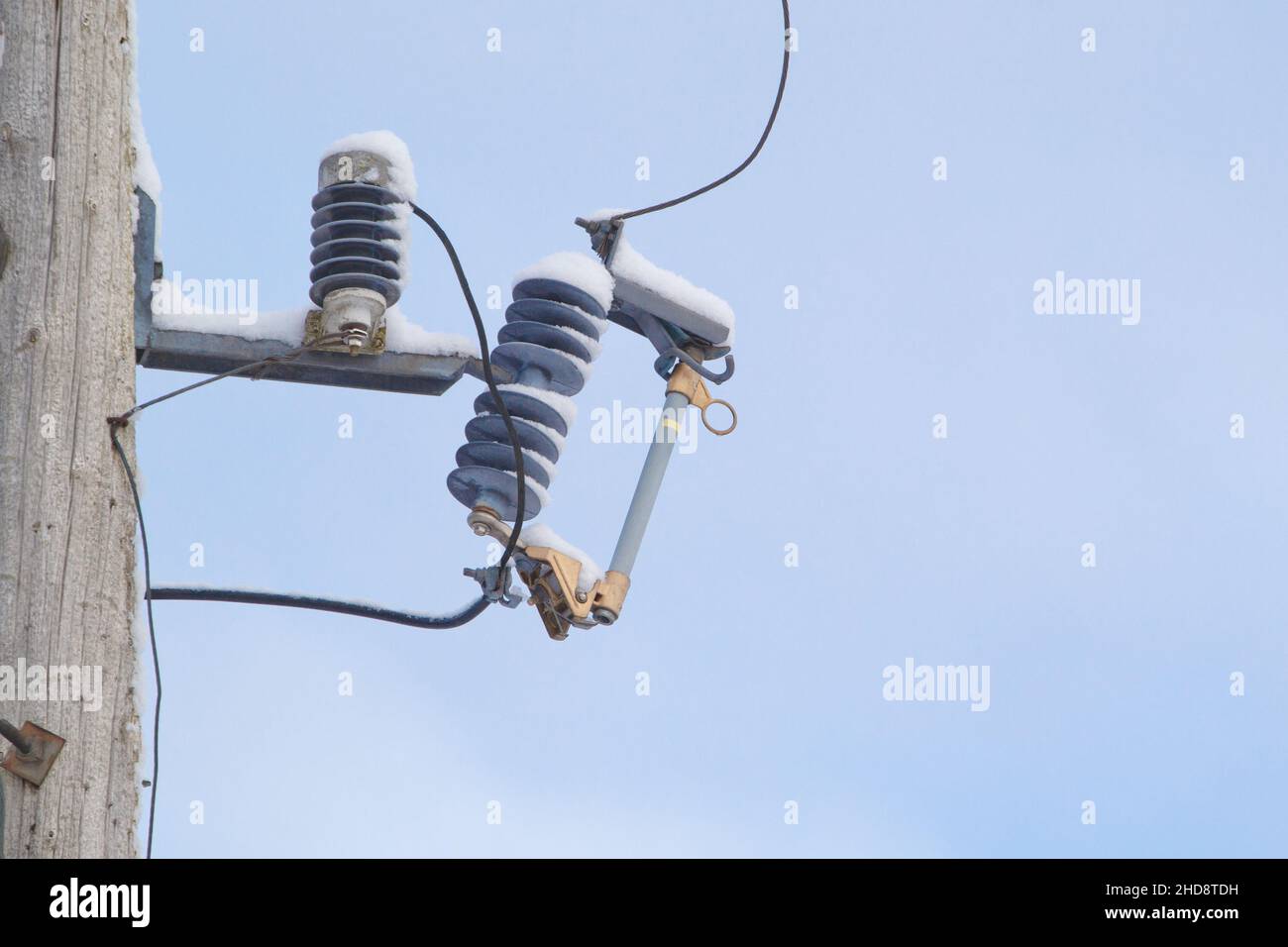 Telephone or utility power pole fuse and surge protector during Winter ...