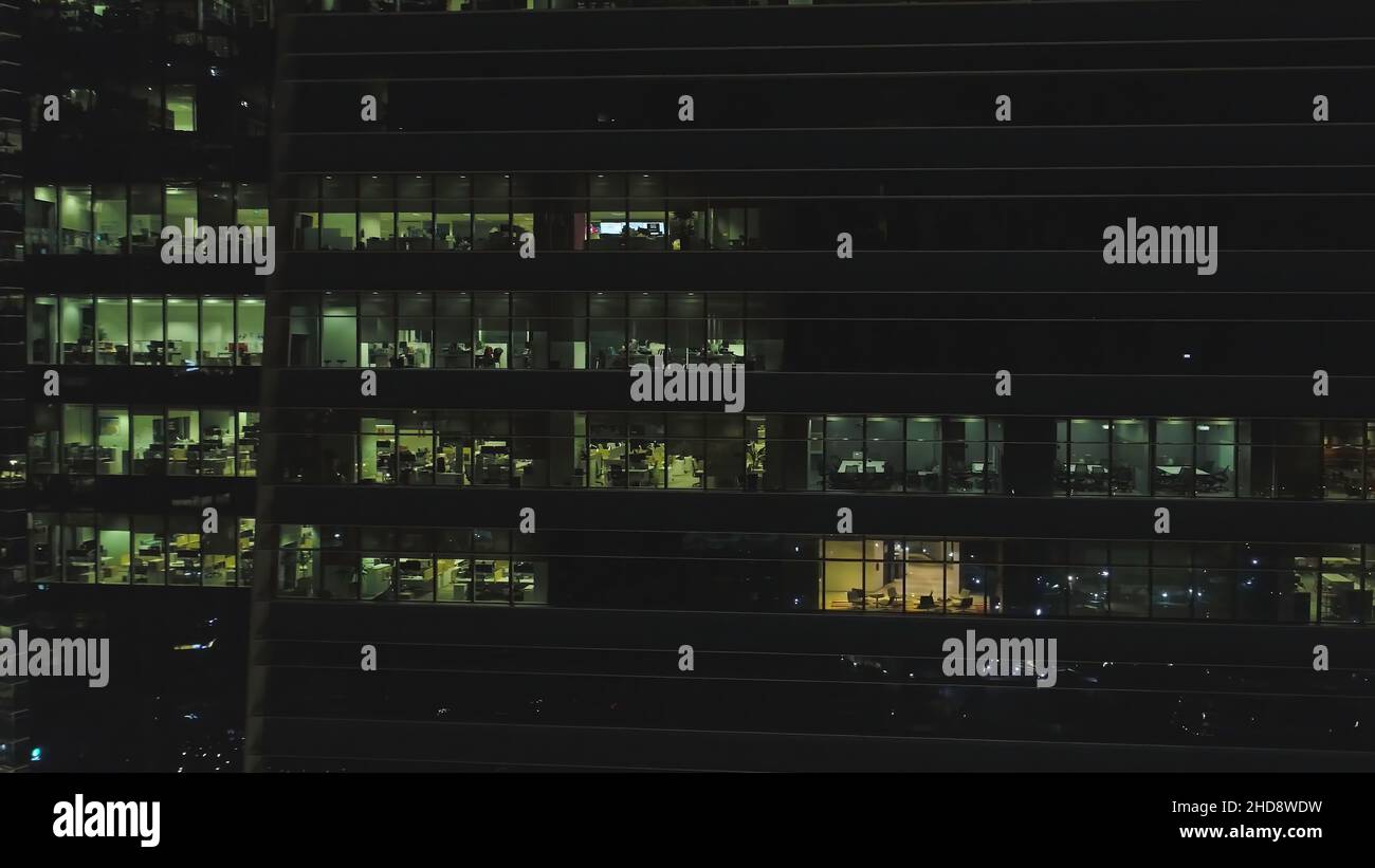 Frontal view of the night facade of building with a lot of lighted ...