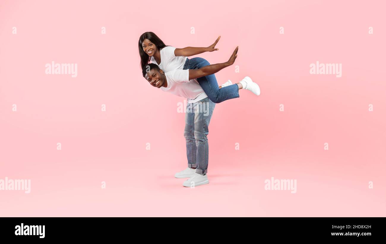 African American man riding woman on his back Stock Photo - Alamy