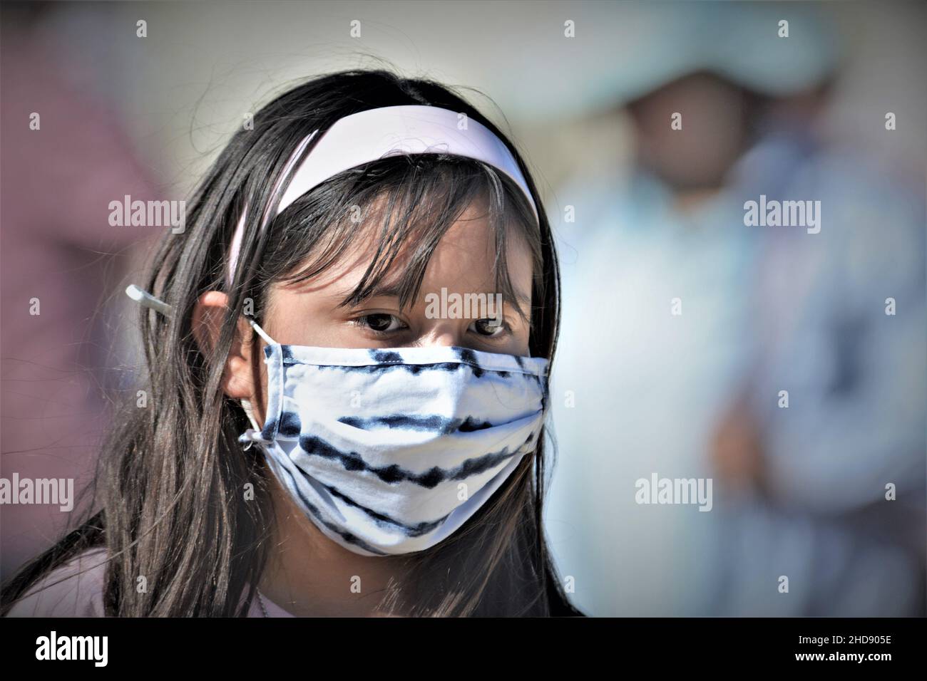 Teen girl face on looking at camera with apprehension during sporting ...