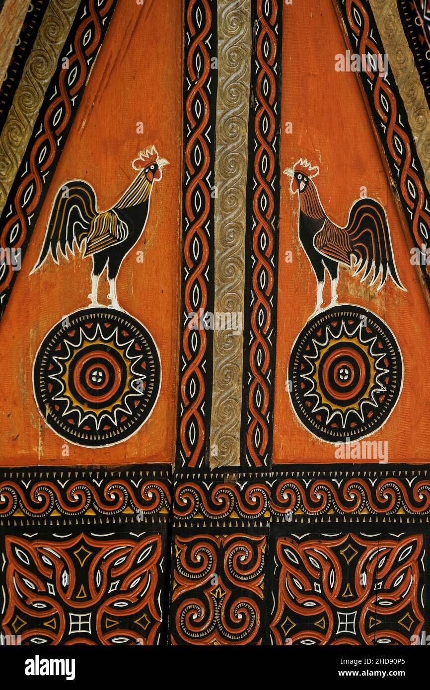 Carved painted cockerel & sun motifs on traditional tongkonan family ...