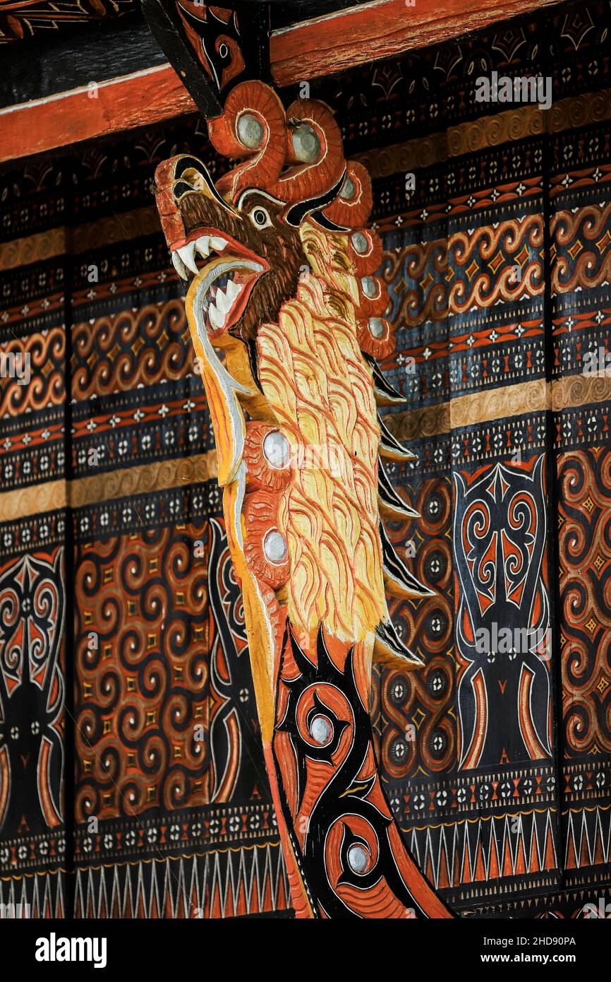Carved & painted dragon figure on a traditional tongkonan family house ...