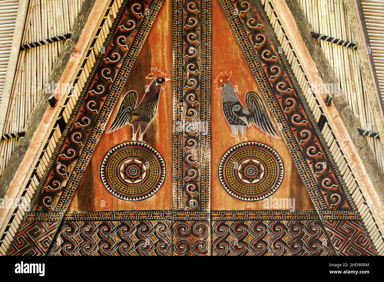 Carved painted cockerel & sun motifs on traditional tongkonan family ...