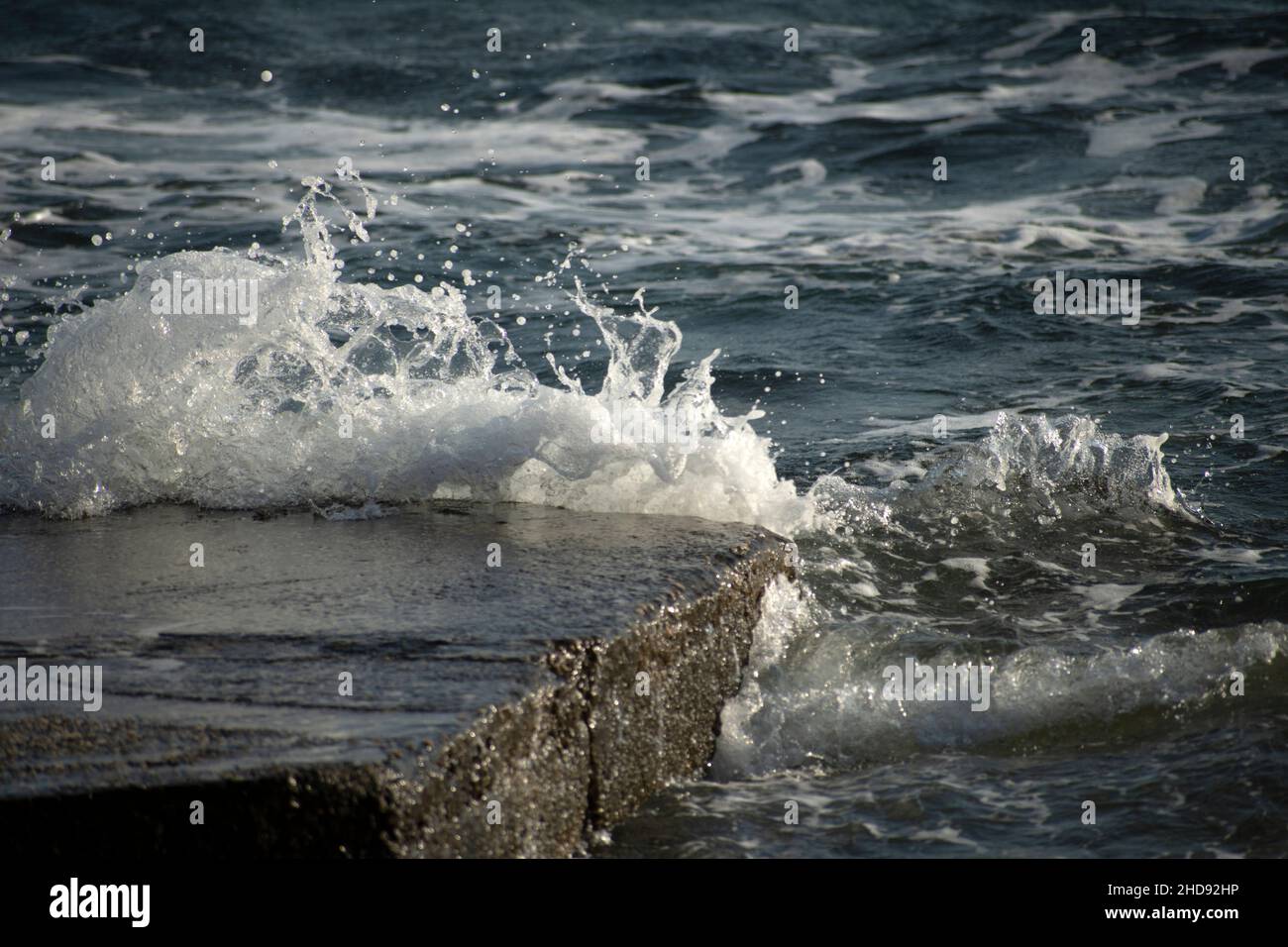 wave hitting a pier Stock Photo - Alamy